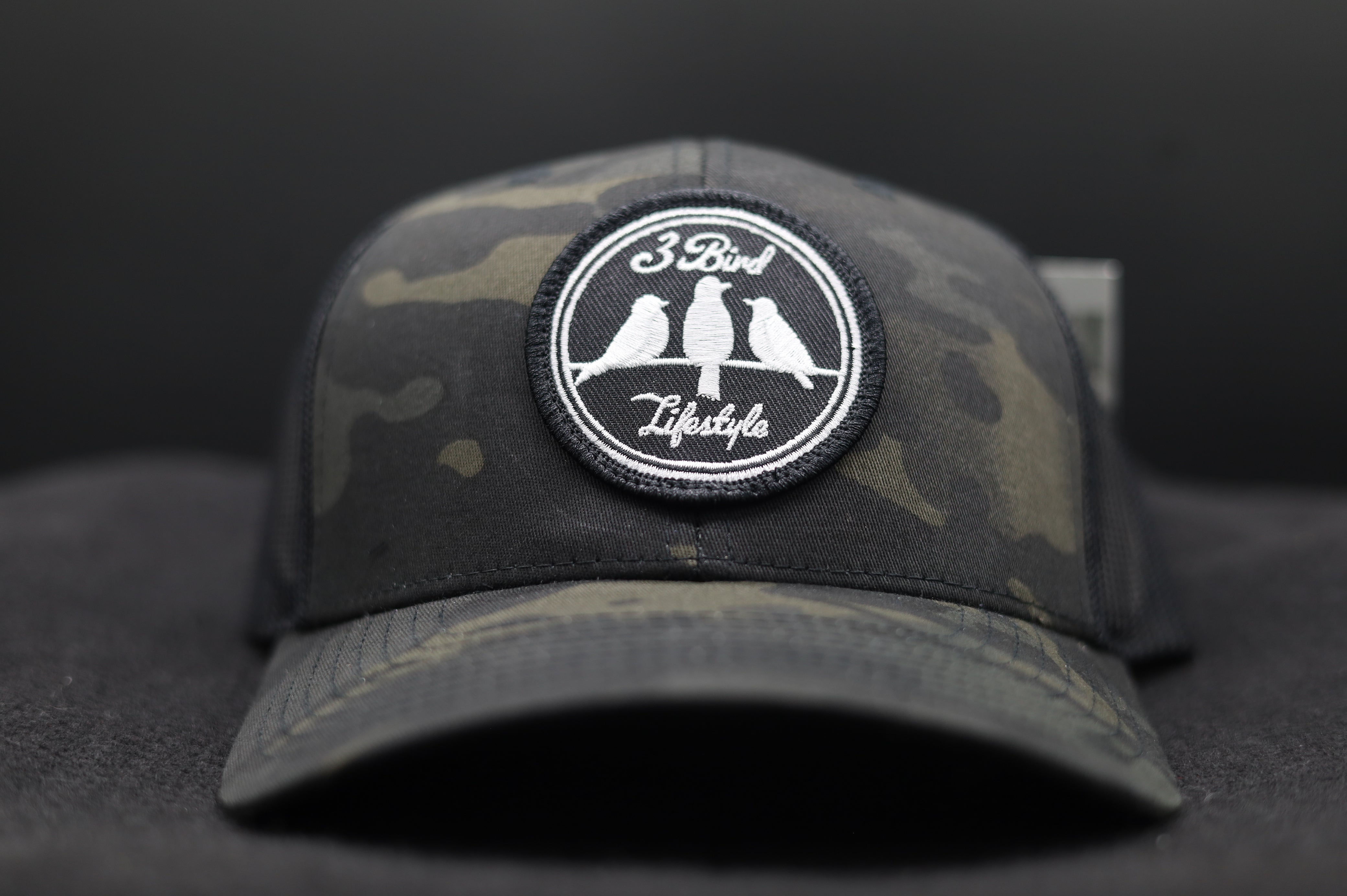 Yupoong Trucker Hat •Multicam Black & Black • 3 Bird Lifestyle Patch